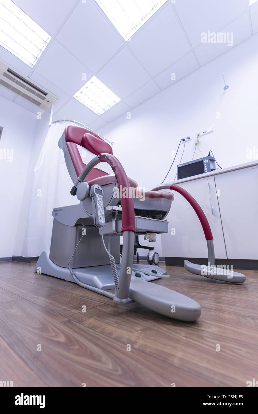 Modern dental chair in a sterile, bright environment with wooden floor ...