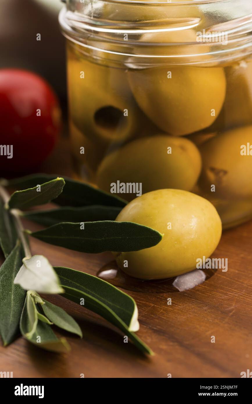 Pickled olives and olive tree branch Stock Photo - Alamy