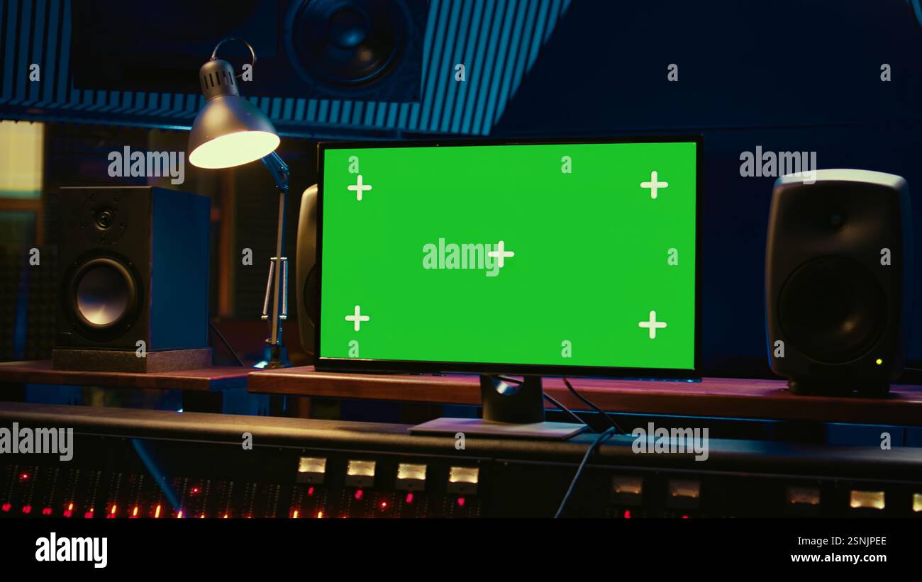 Control room with greenscreen running on computer next to buttons and ...