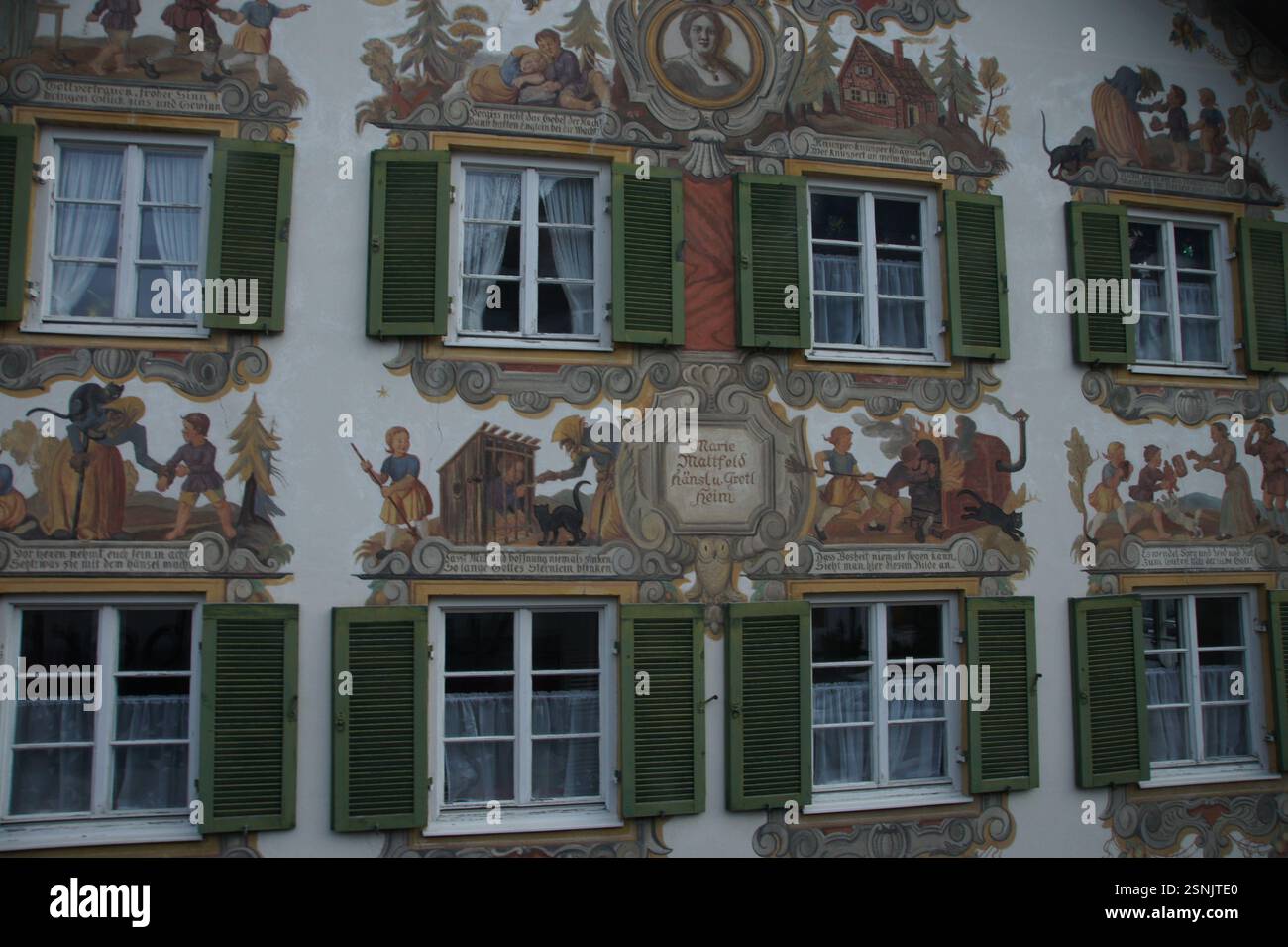 A colorful building with elaborate murals depicting scenes from the ...
