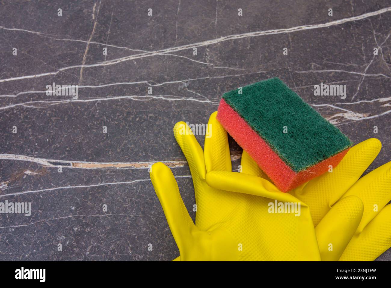 Cleaning Equipment: Yellow Rubber Gloves and Scrubbing Sponge on Marble ...