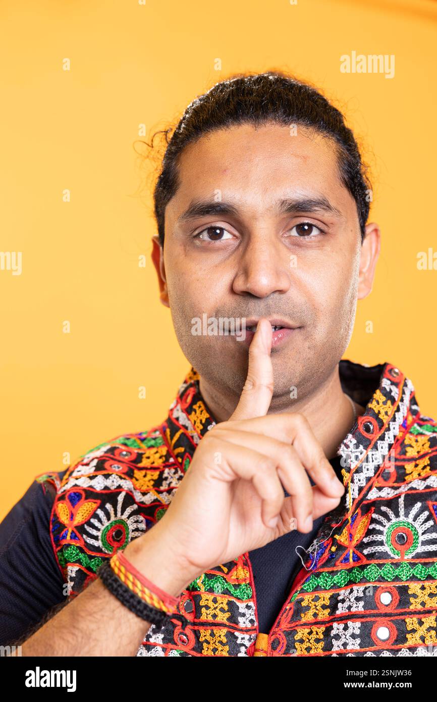 Firm man doing shushing hand gesturing, giving criticism irritated by ...