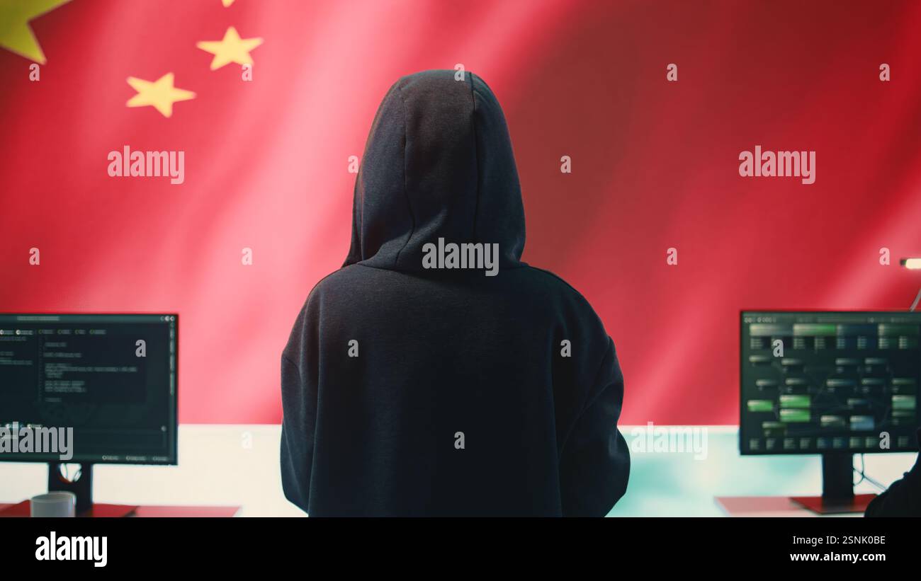 Governmental hacker in high tech office with Chinese flag shown on big ...