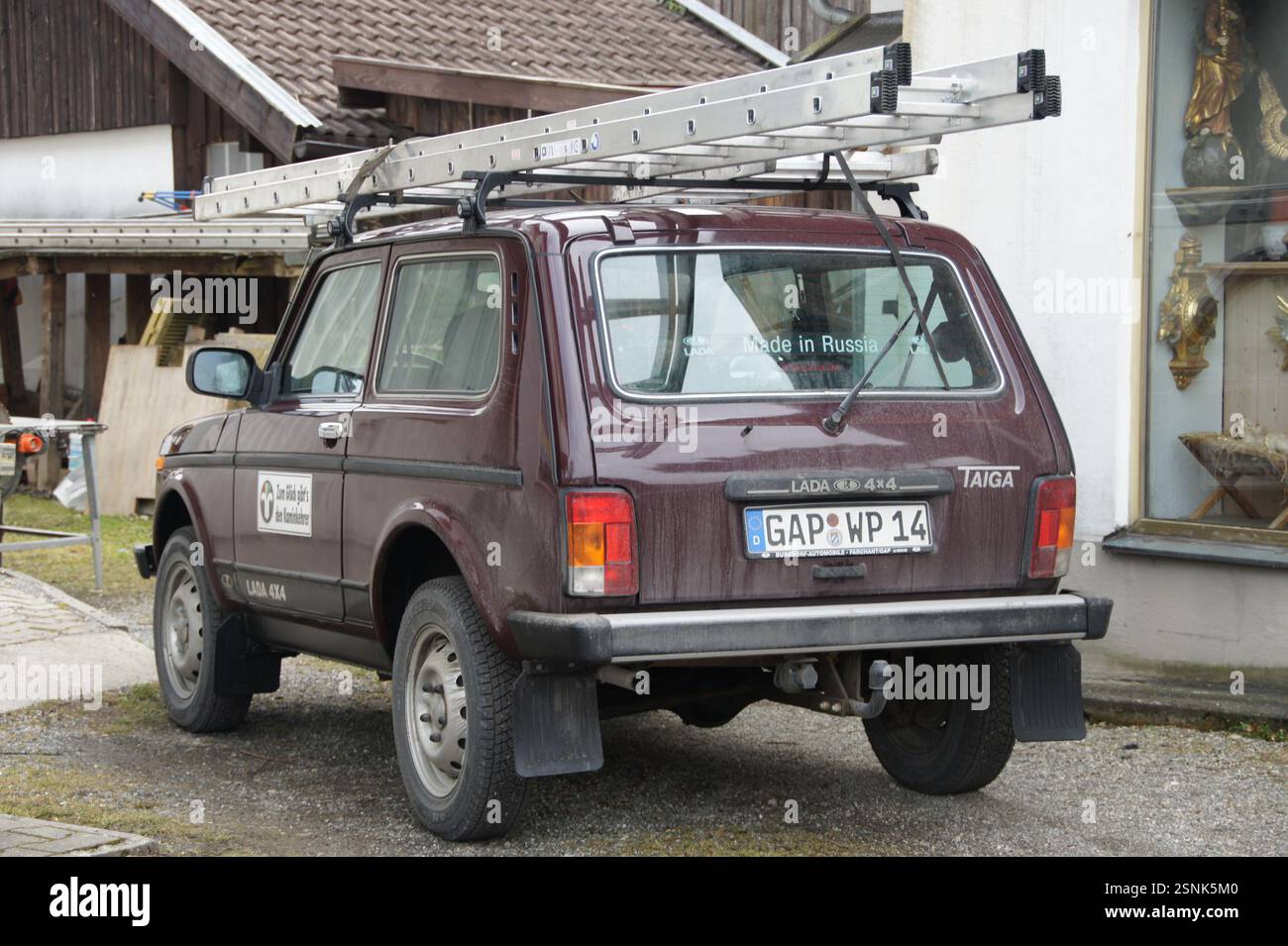 A red Lada Niva 4x4 with a ladder on top, spotted in Germany, Munich ...