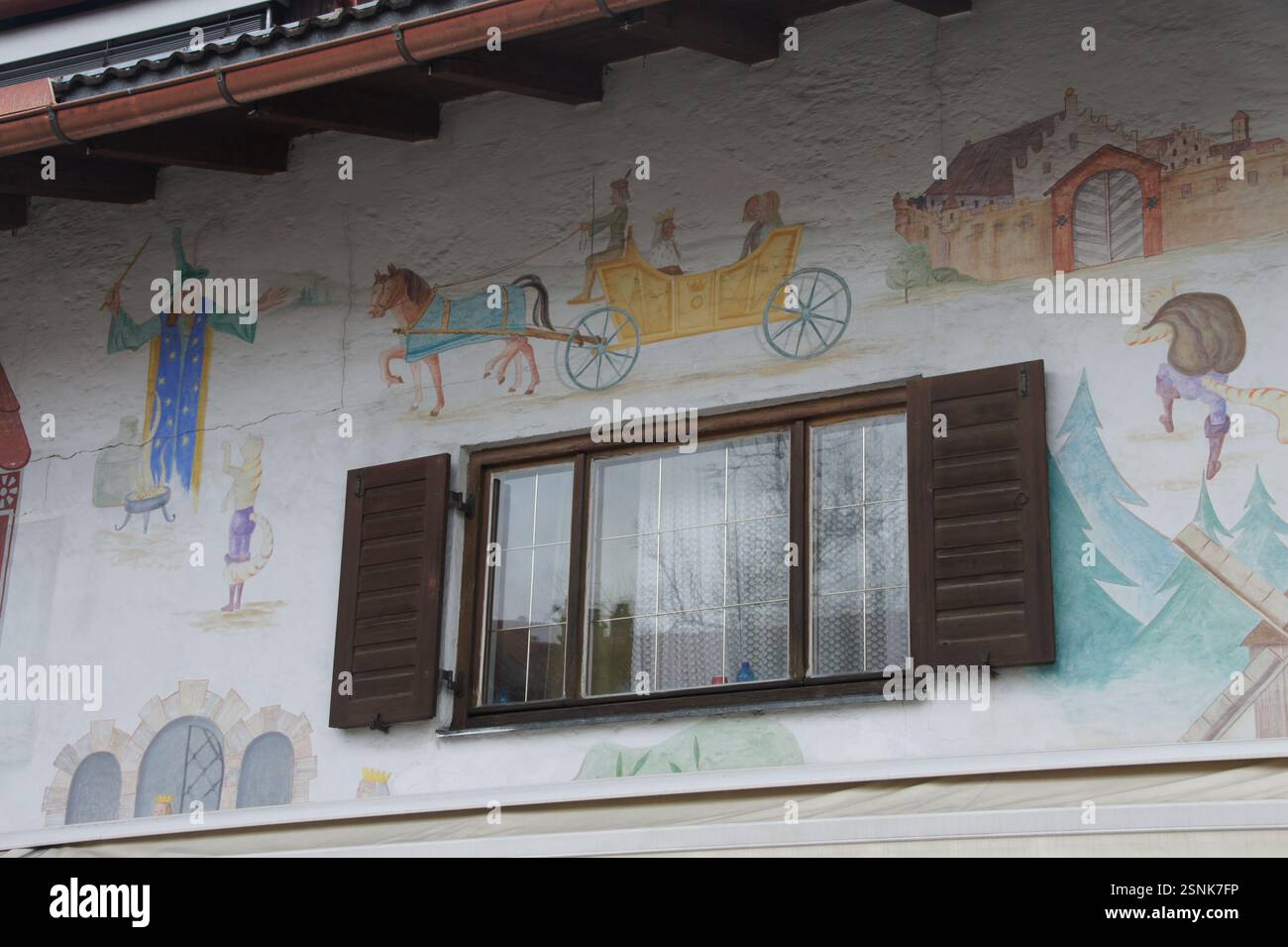 A mural in Germany, Munich, depicts a wizard riding in a horse-drawn ...