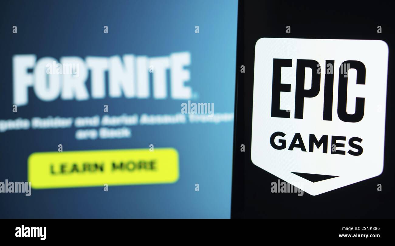 Epic games logo is visible on smartphone and fortnite in the background ...