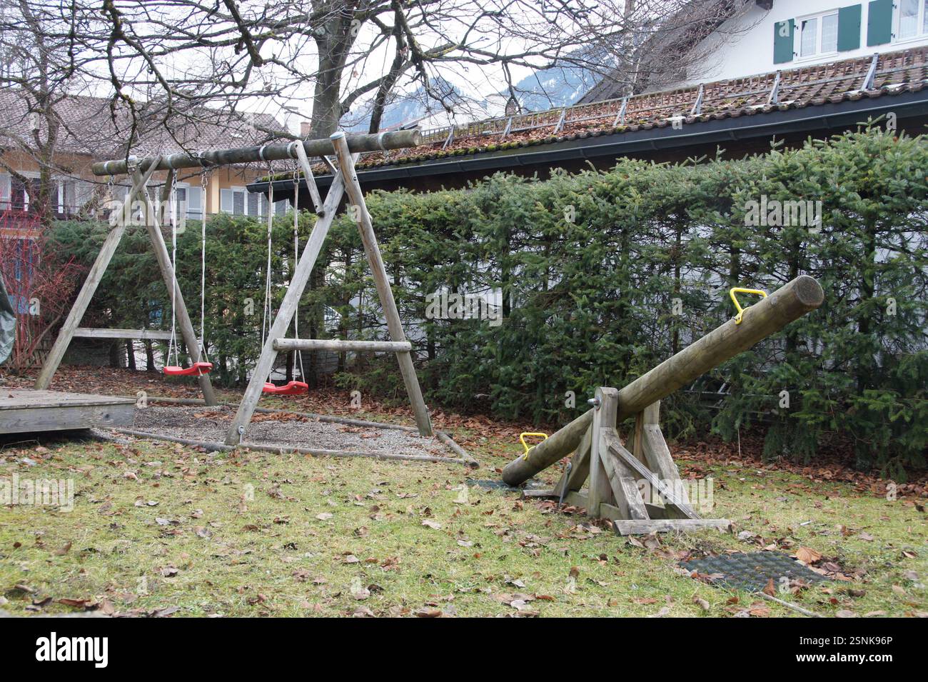 A classic wooden swing set in a backyard in Germany, Munich. Simple ...