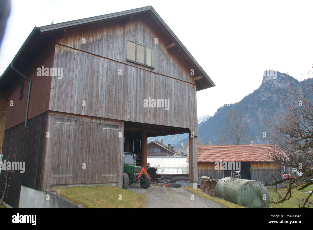 A weathered wooden barn with a silo stands tall in rural Germany ...