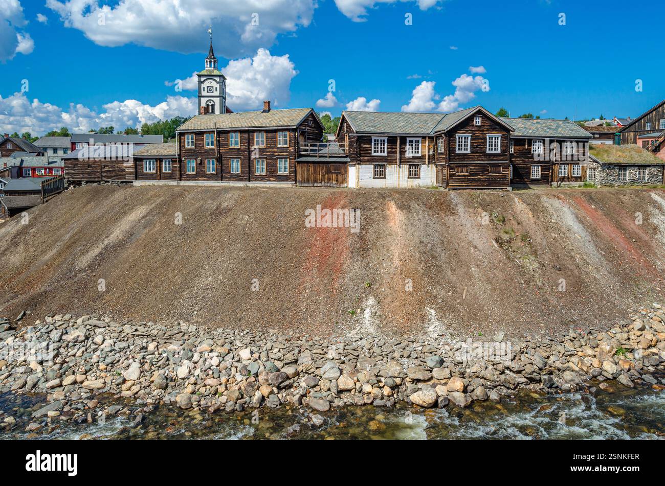 Traditional wooden houses on the banks of the river in the mining ...