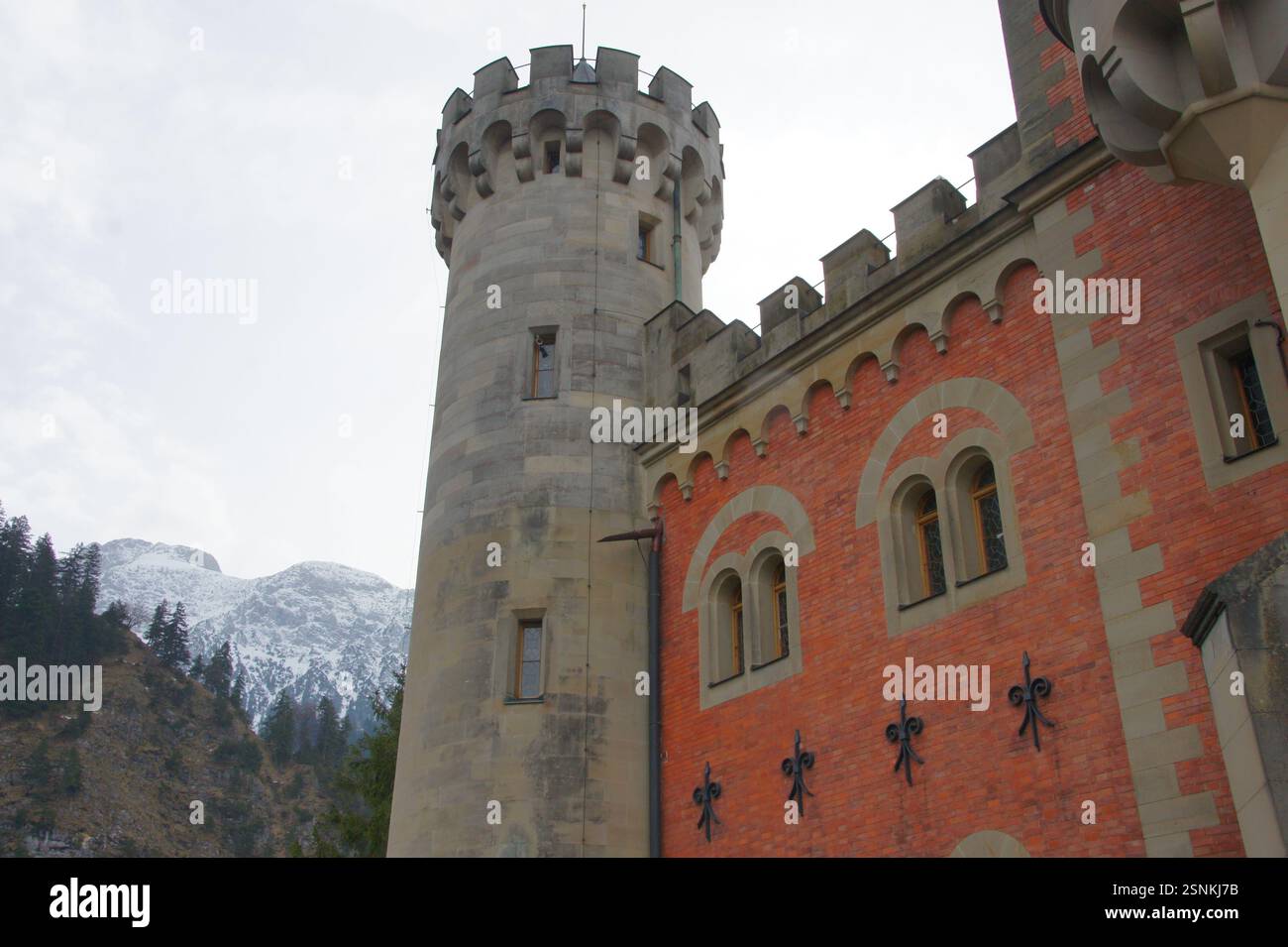 A red-brick castle entrance with a clock tower stands in Germany ...