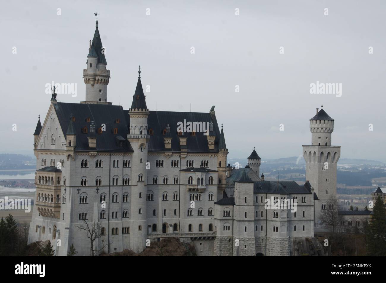 Germany, Munich. Two castles stand on a hill overlooking a lake. The ...