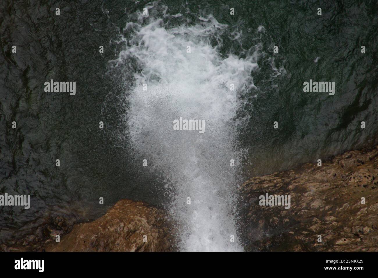 Germany, Munich. A close-up view of a powerful waterfall cascading down ...