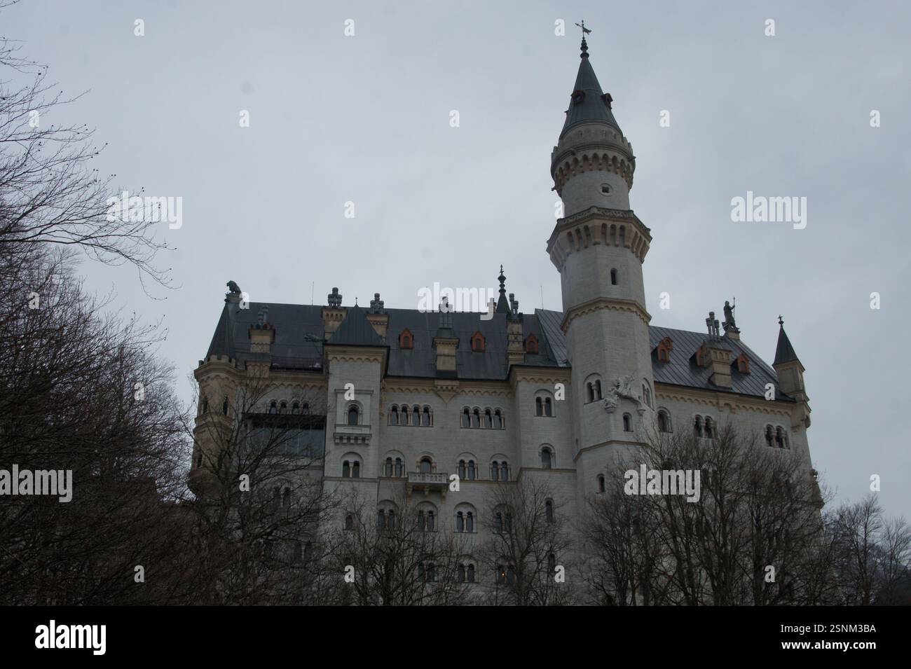 In Germany, Munich, stands a white castle with a tall clock tower ...