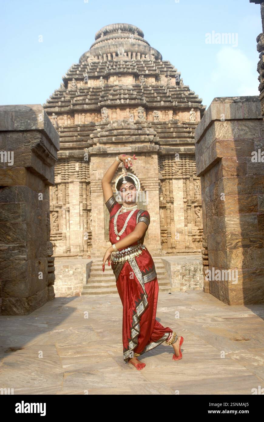 Dancer performing classical traditional odissi dance in front of Konarak Sun temple, Konarak ...