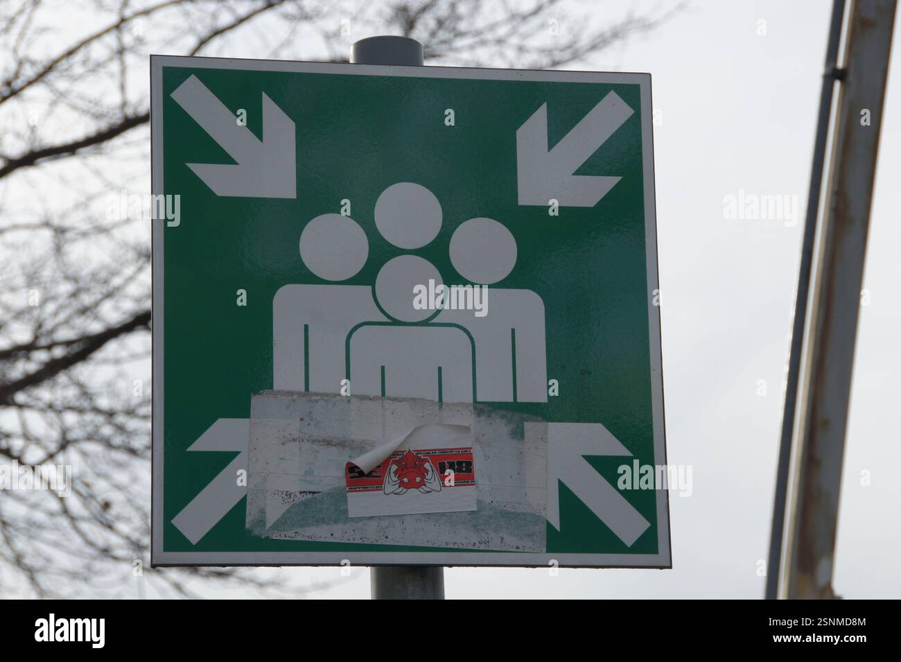 In Germany, Munich, a green exit sign with a sticker catches the eye ...