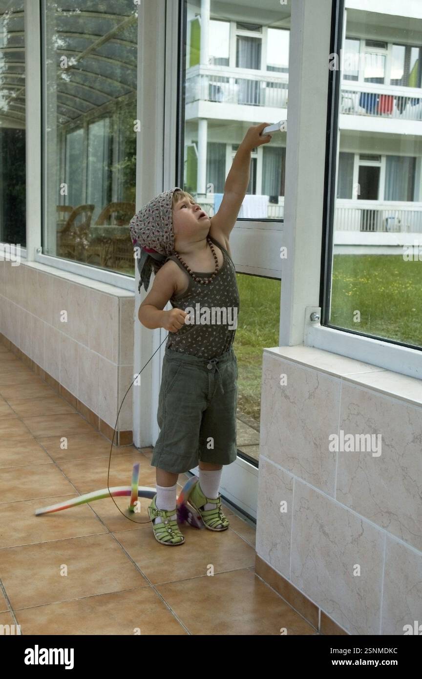 Kid reaching door hi-res stock photography and images - Alamy