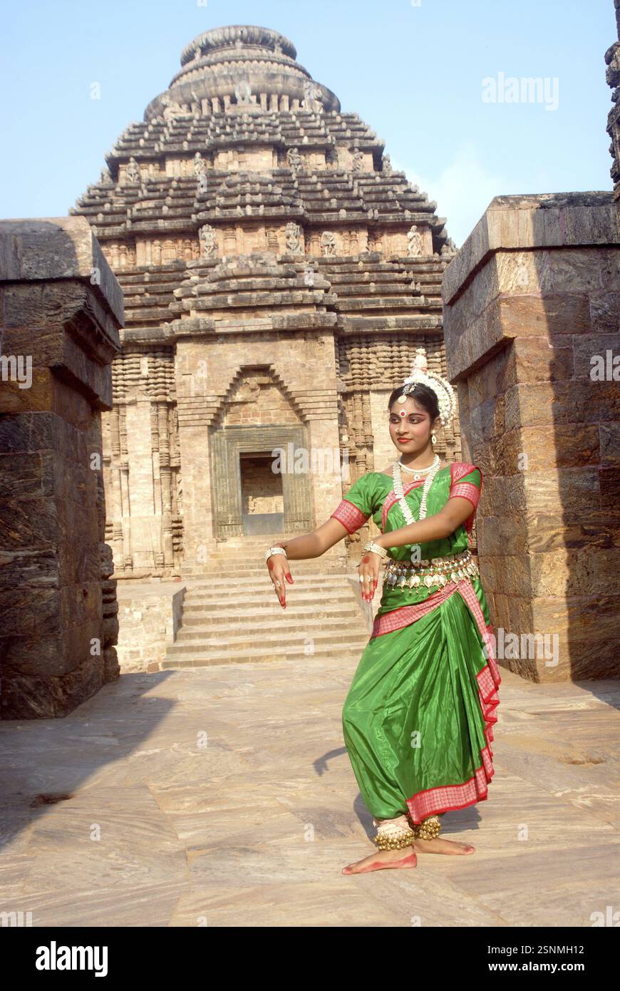 Dancer performing classical traditional odissi dance in front of Konarak Sun temple, Konarak ...
