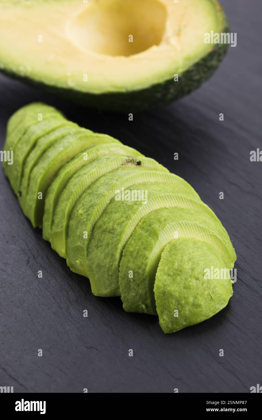Ripe cleaned peeled avocado sliced Stock Photo - Alamy