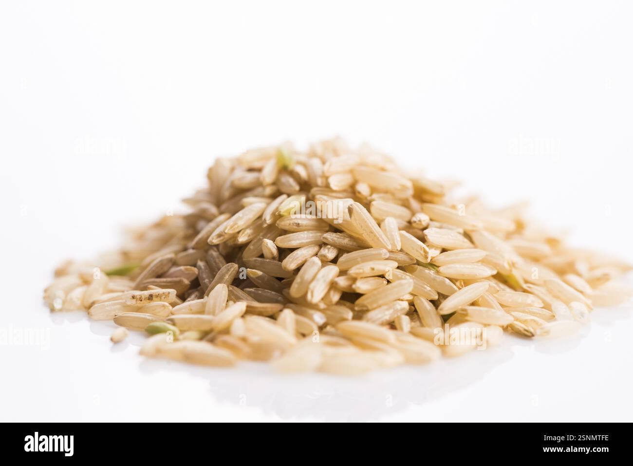 Whole rice pile on white background Stock Photo - Alamy