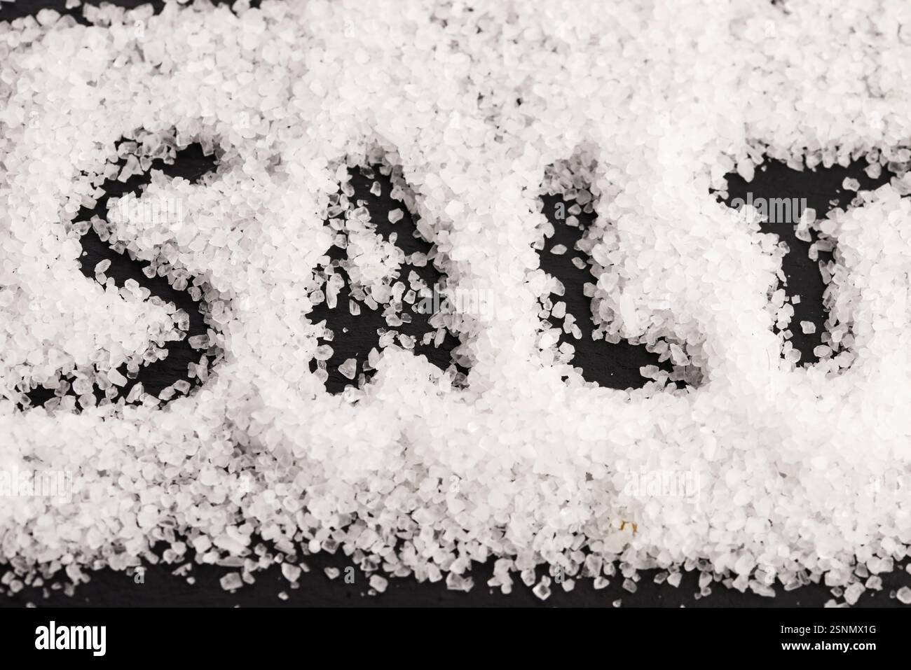 The word salt written into a pile of white granulated salt Stock Photo ...