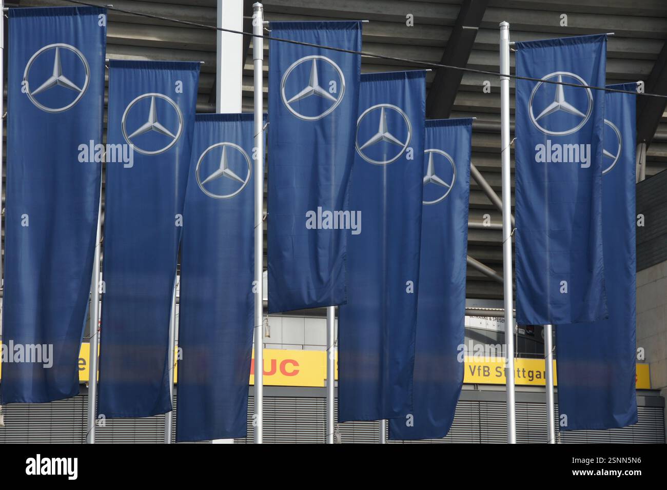 A row of blue flags with the Mercedes-Benz logo waves in front of a ...
