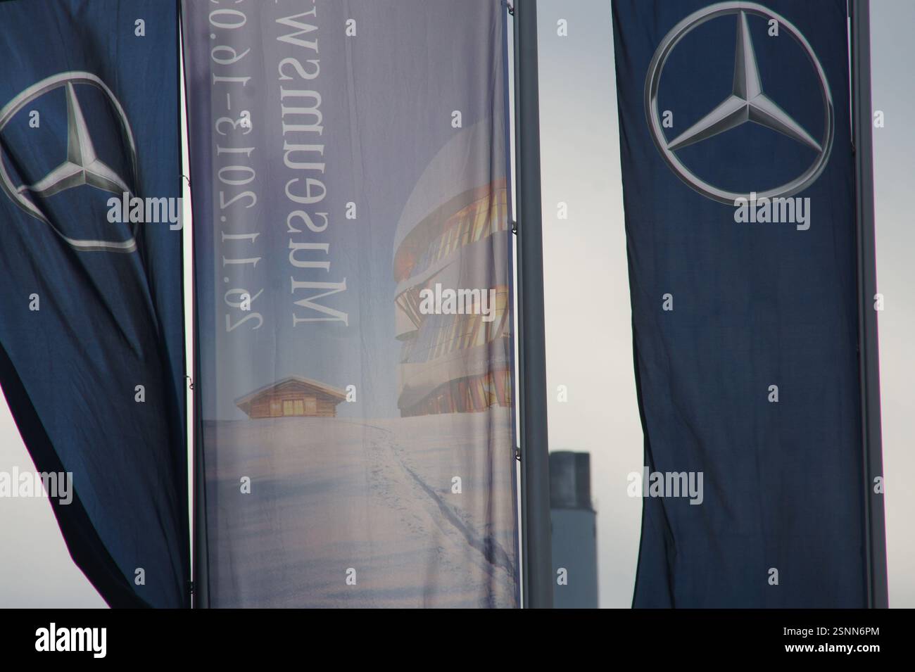 Two black Mercedes-Benz flags flutter in the wind, possibly for a brand ...
