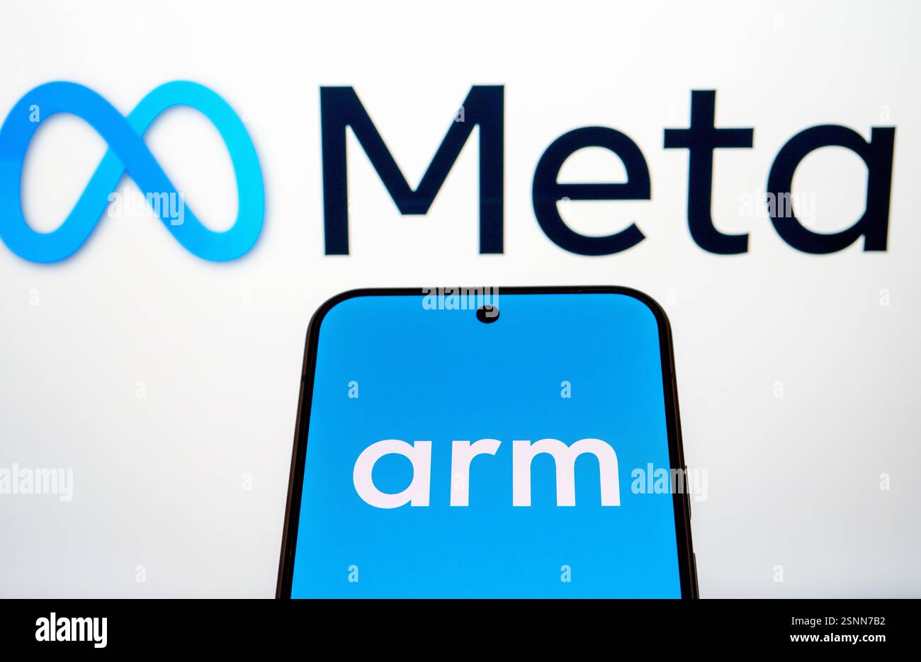 ARM Holdings logo on smartphone and Meta Platforms logo seen on the blurred background. Concept ...