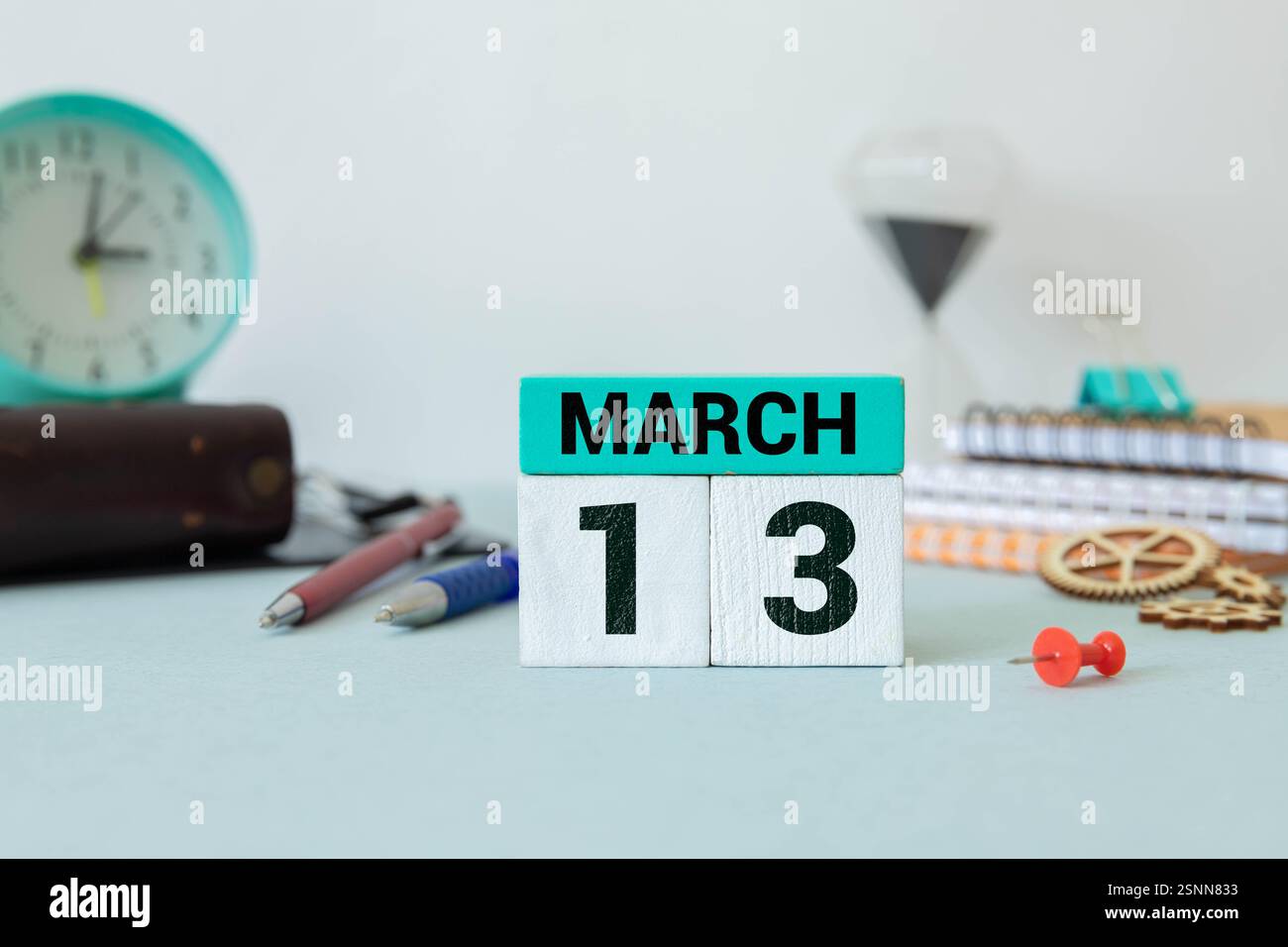 Wooden block calendar with date March 13 on colored Stock Photo - Alamy