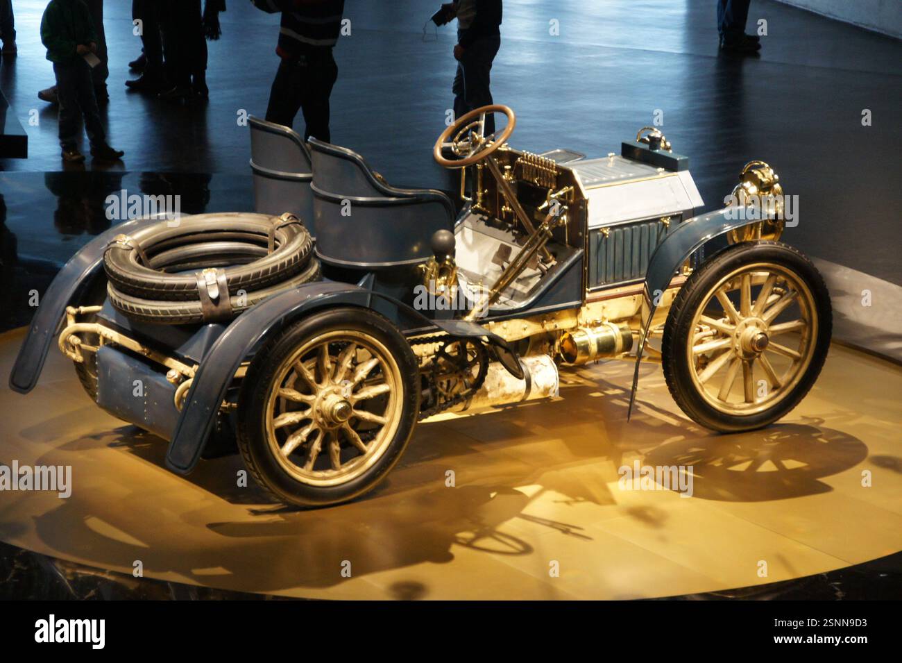 A black and gold Mercedes-Benz Simplex with a wooden steering wheel is ...