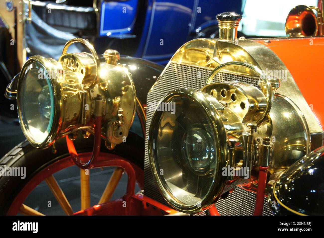Shiny brass headlights gleam on a vintage car in Germany, Munich. The ...