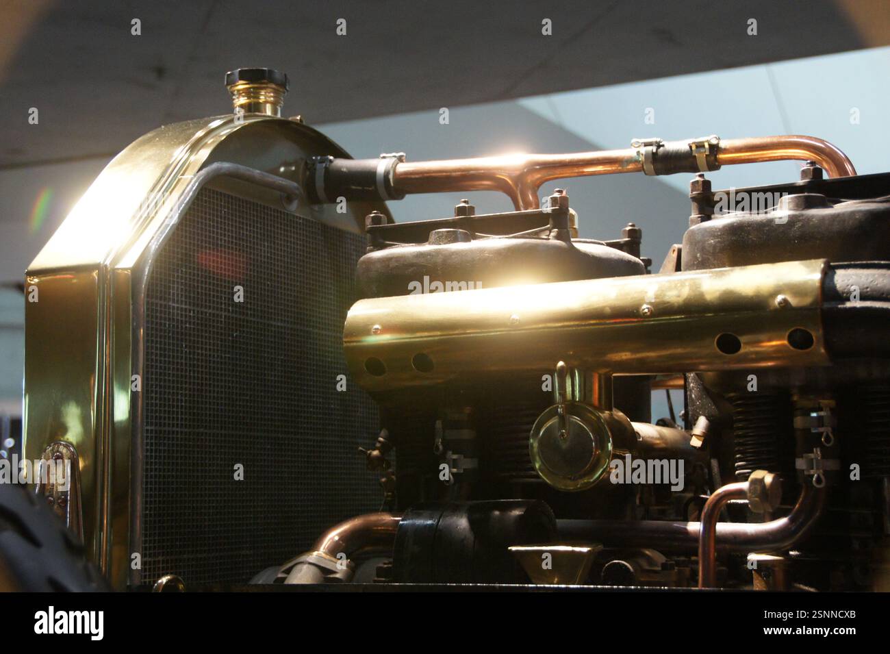 Germany, Munich. A close-up of a vintage car engine reveals a brass ...