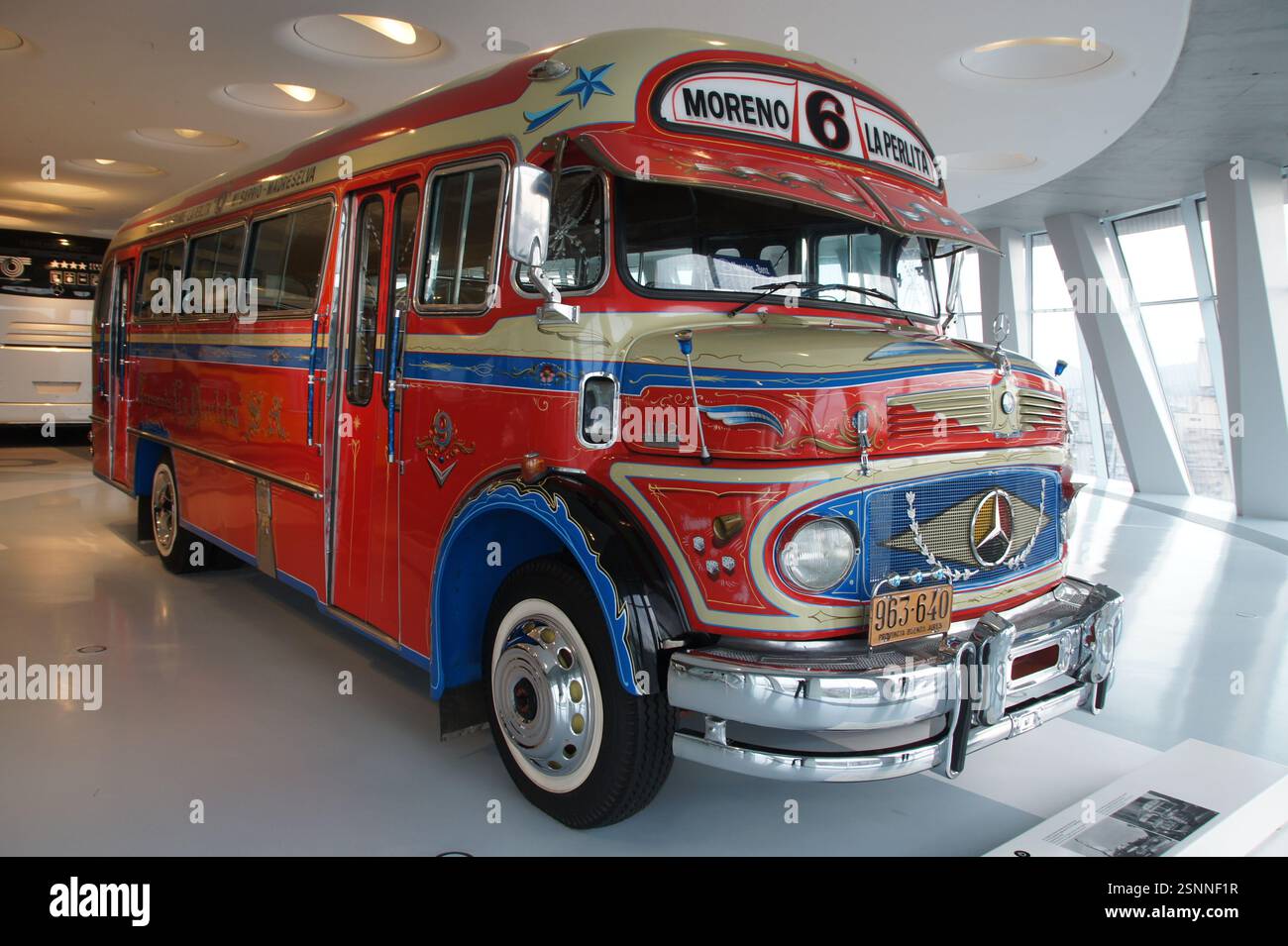A vintage Mercedes-Benz bus, its vibrant paintwork and ornate detailing ...