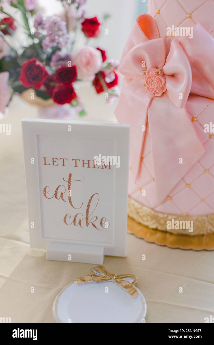 A delightful cake is showcased alongside a charming sign inviting ...