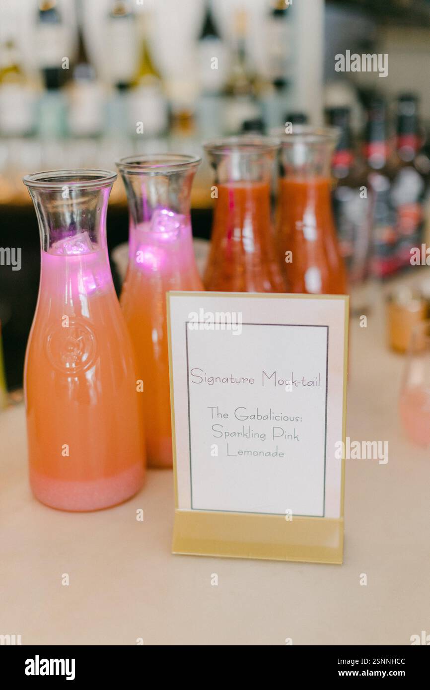 Two colorful mocktails are elegantly displayed at a daytime event ...