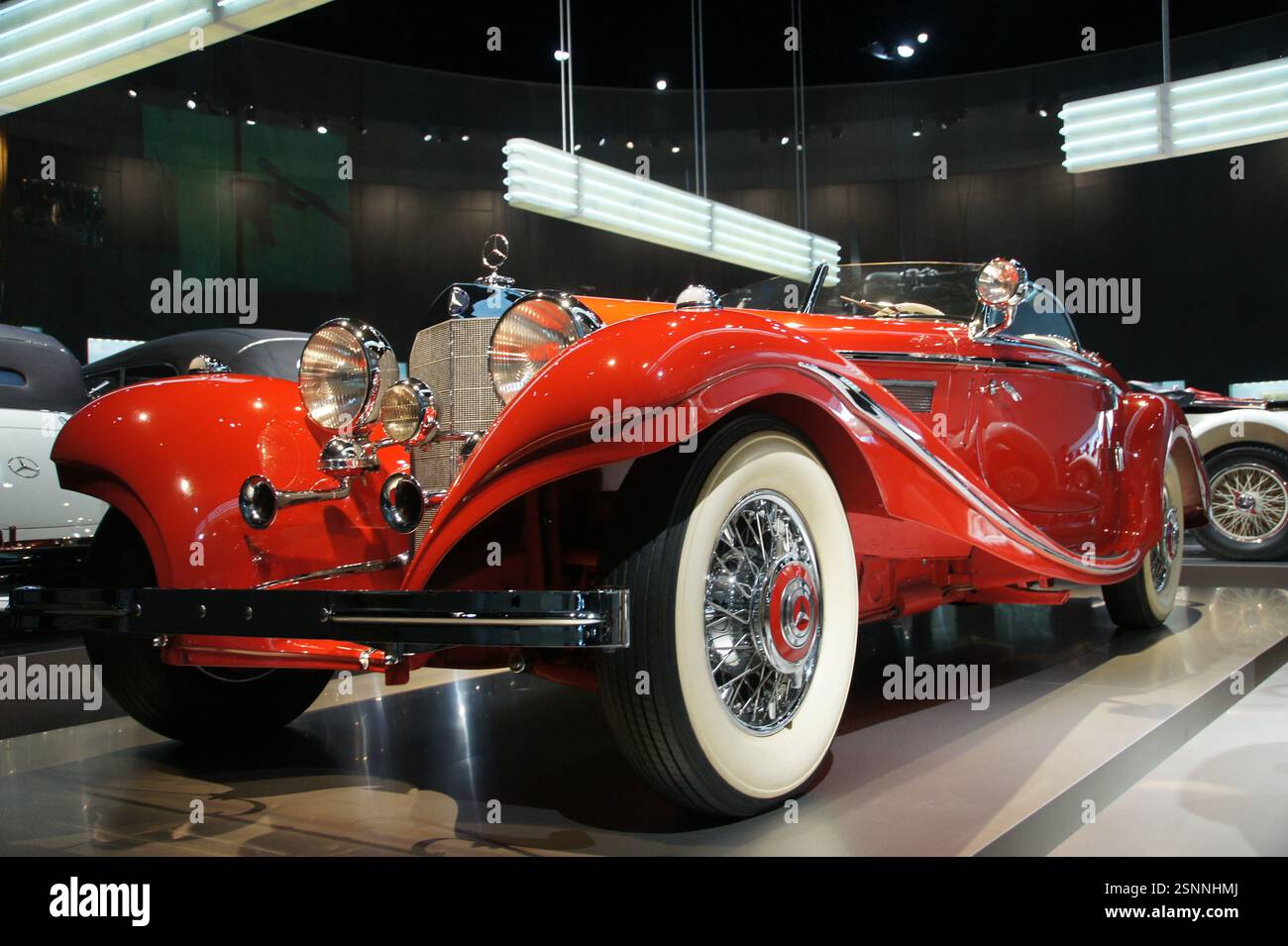 A gleaming red Mercedes-Benz 500 K Spezial-Roadster with chrome accents ...