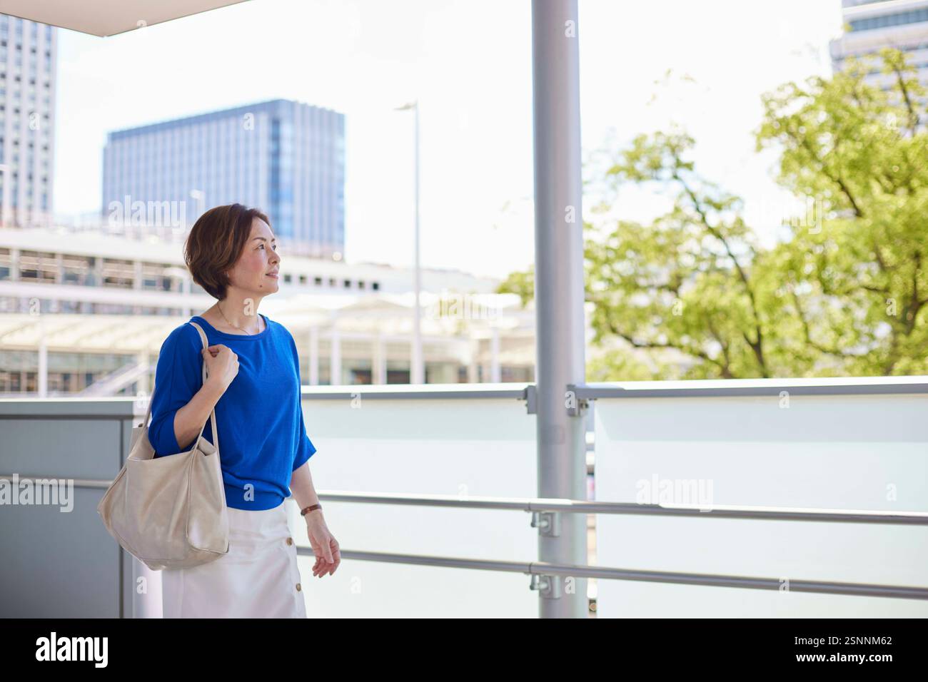 Japanese businesswoman walking down station aisle Stock Photo - Alamy