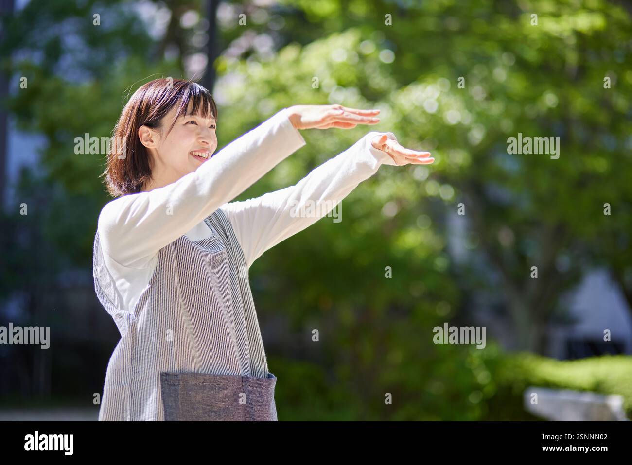 Smiling childcare worker woman Stock Photo - Alamy