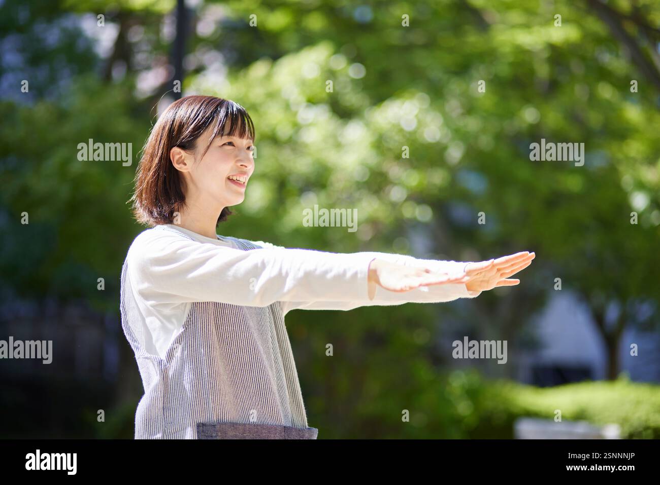Smiling childcare worker woman Stock Photo - Alamy