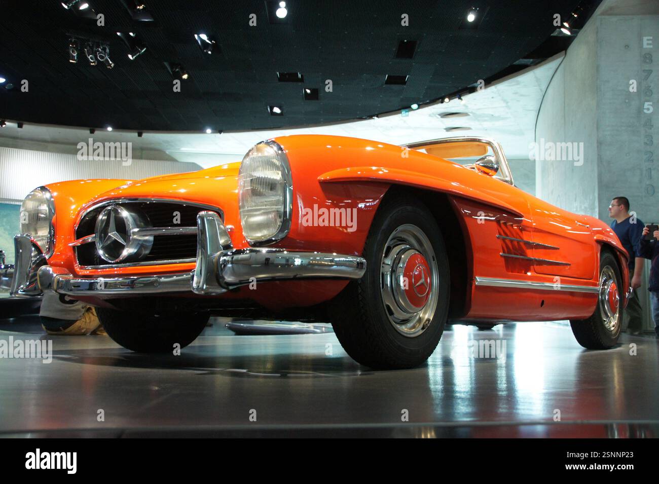 Germany, Munich. A vibrant orange Mercedes-Benz 300 SL Roadster with ...