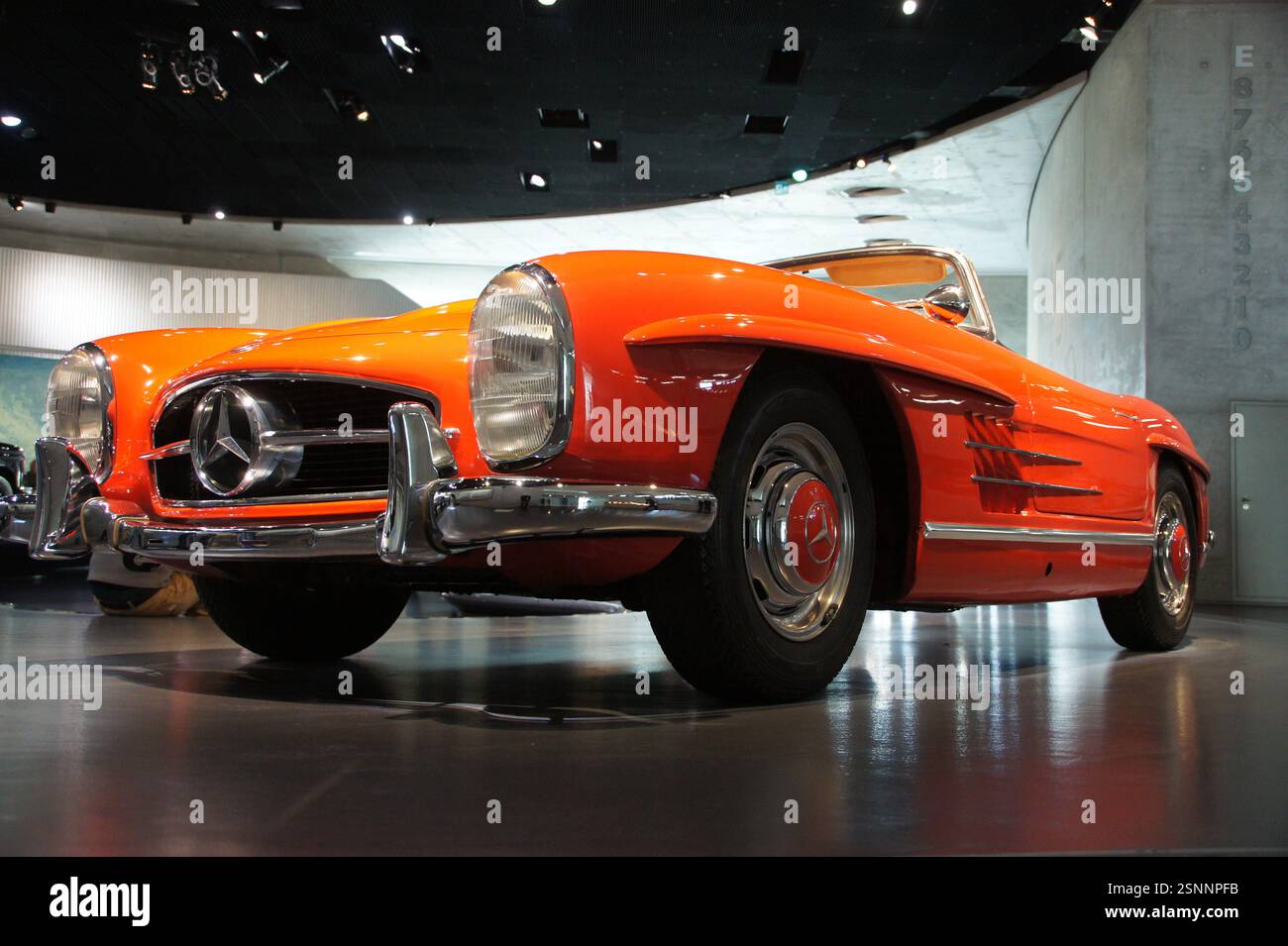 The Mercedes-Benz 300 SL Roadster, gleaming in orange paintwork, boasts ...