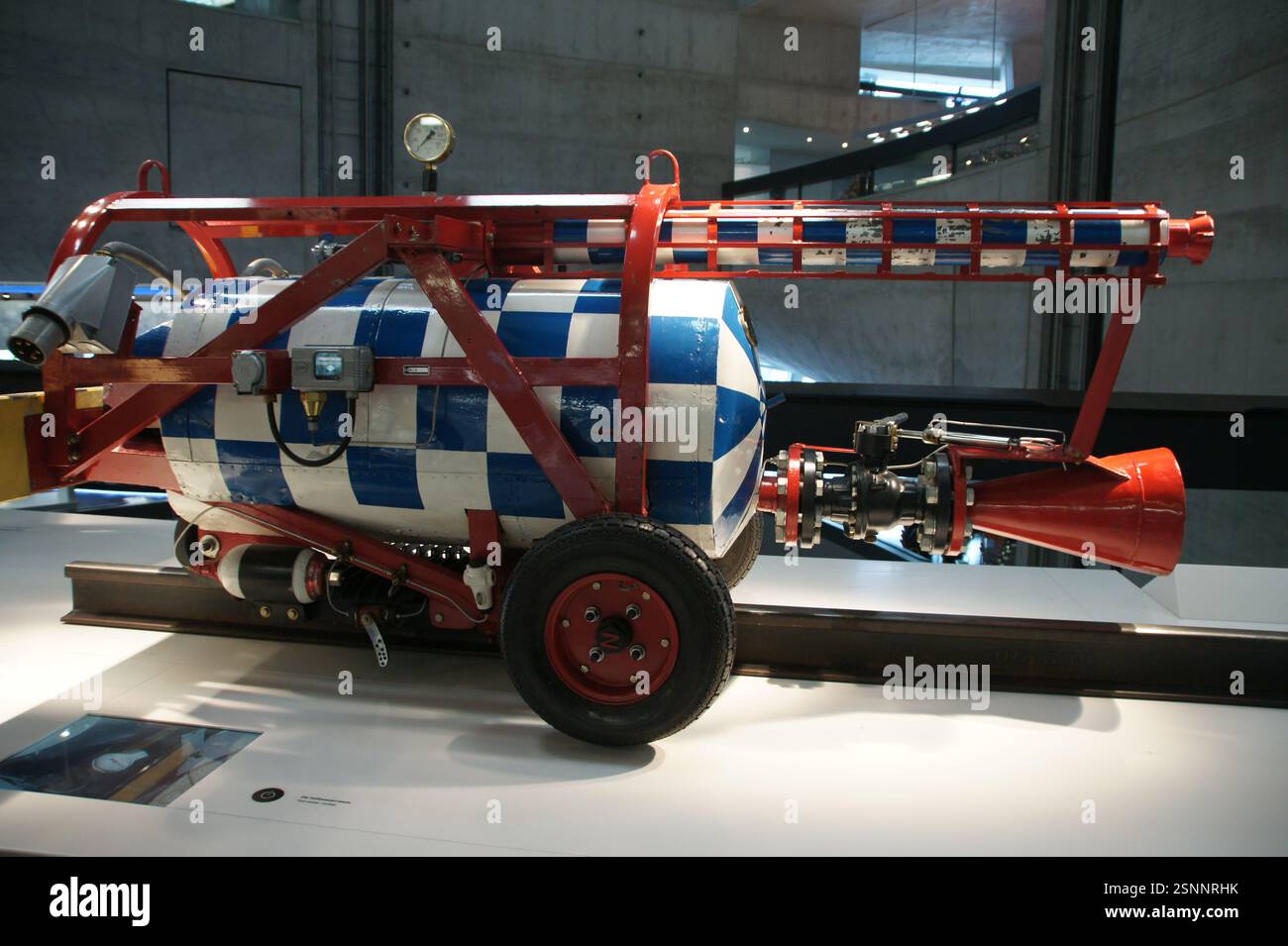 A red and white checkered wind tunnel model with wheels is used in ...