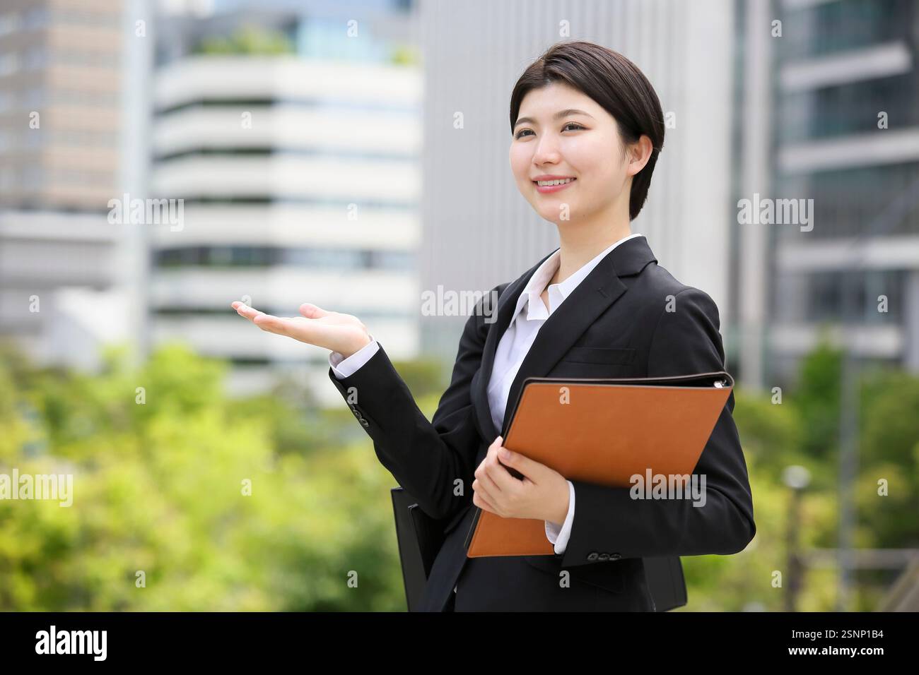 Businesswoman showing the way Stock Photo - Alamy