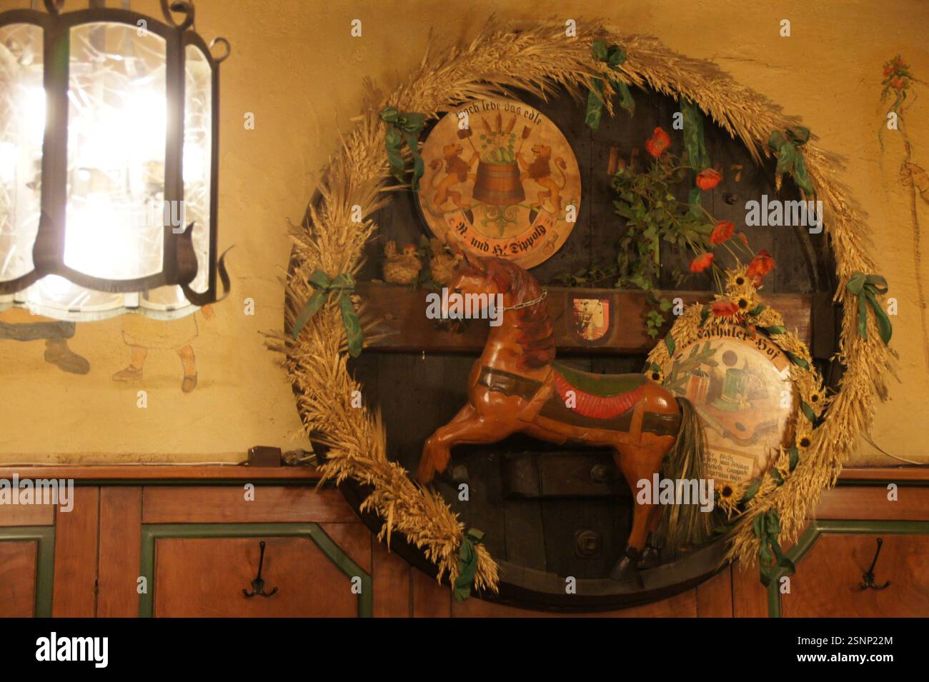 In Germany, Munich, a vintage wooden horse decor hangs on a restaurant ...