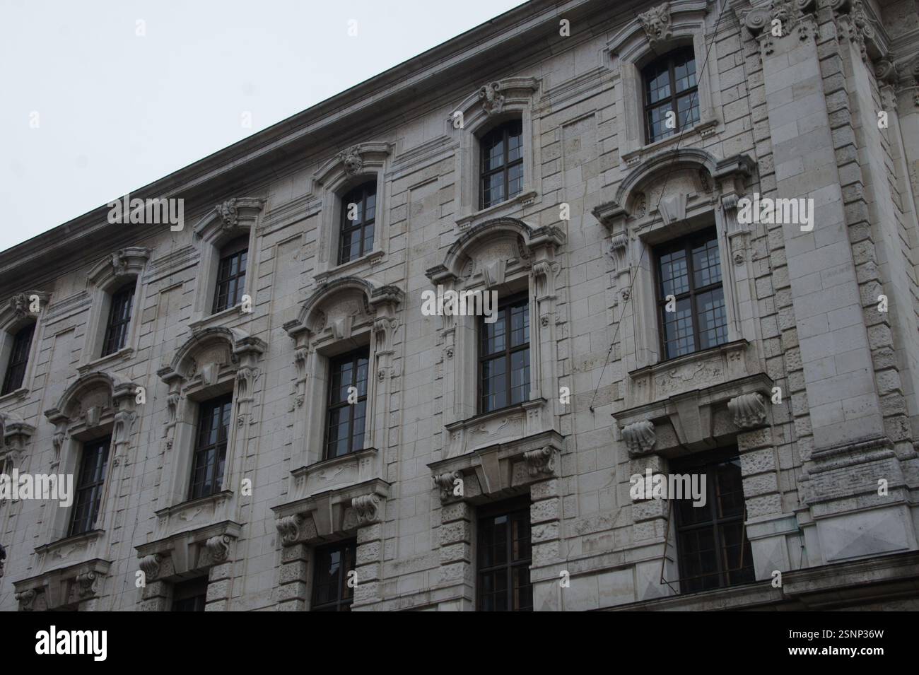 Germany, Munich. A grey stone building with multiple windows and ...