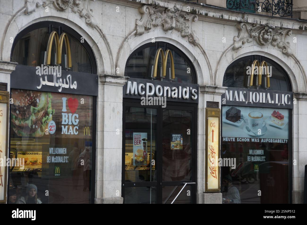 Germany, Munich. McDonald's restaurant facade with multilingual signage ...