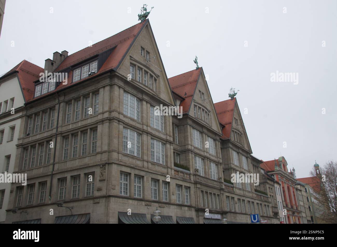 Germany, Munich. Historic building with an ornate facade and red tiled ...