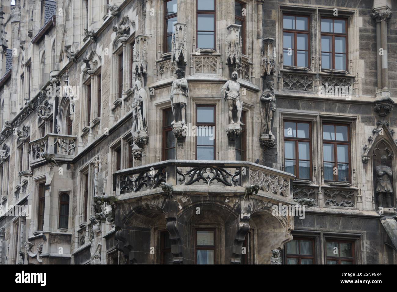 Ornate stone facade with statues and balconies in Munich, Germany ...
