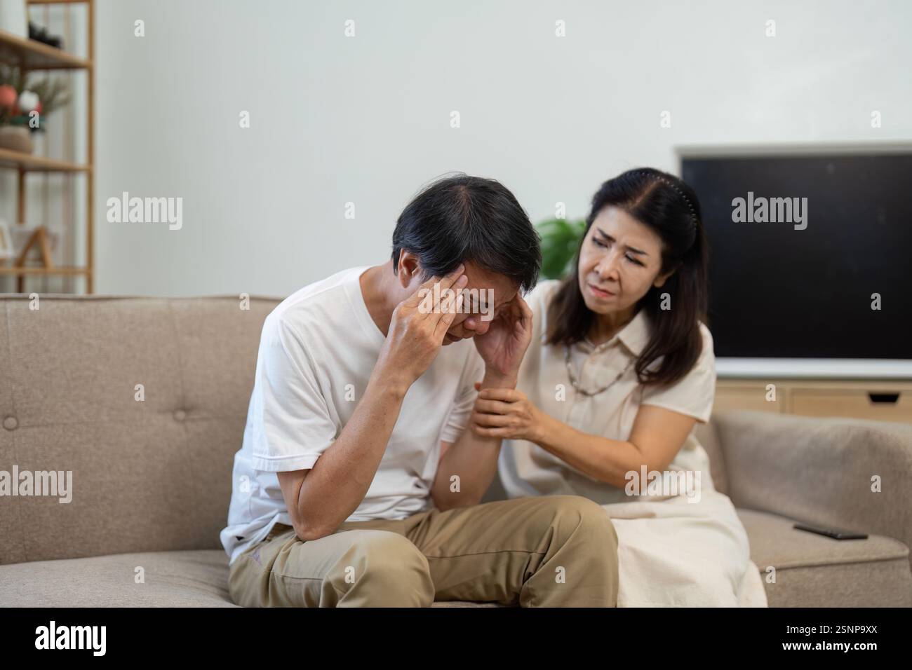 Elderly couple comforting each other during a moment of distress at ...