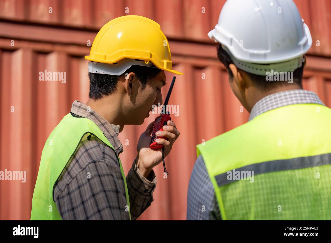 Construction engineers discussing logistics and plans on-site with ...