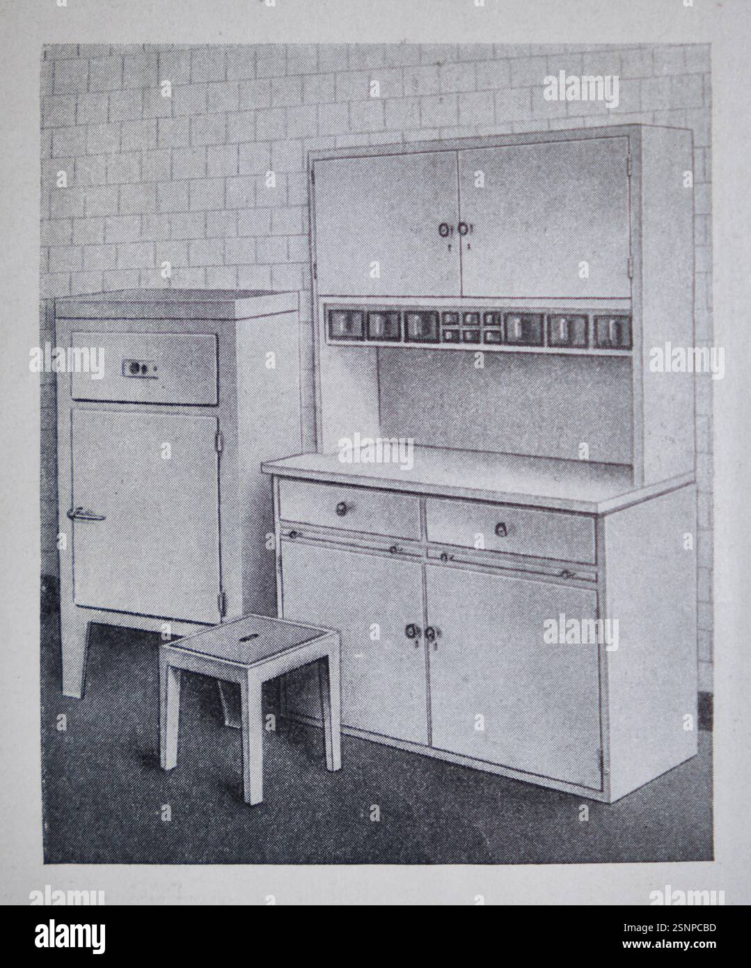 A retro, vintage refrigerator, kitchen cabinet and stool.A black and ...